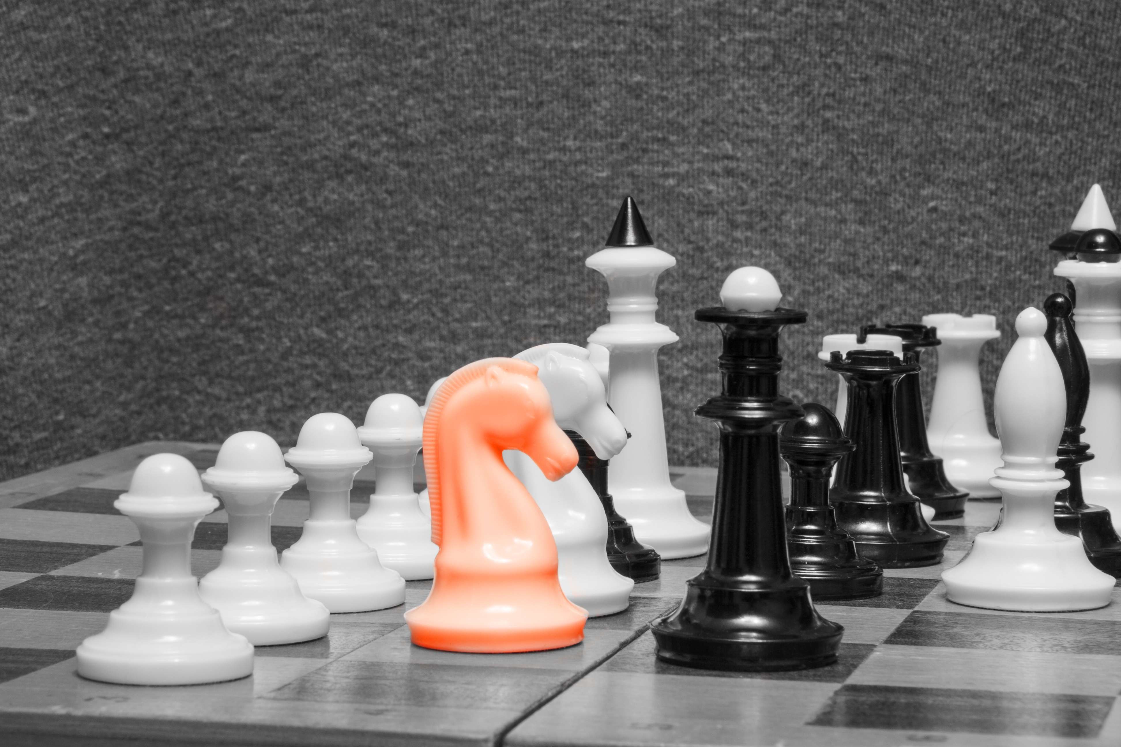 Red chess pieces on a black and white chessboard | Envision your Evolution